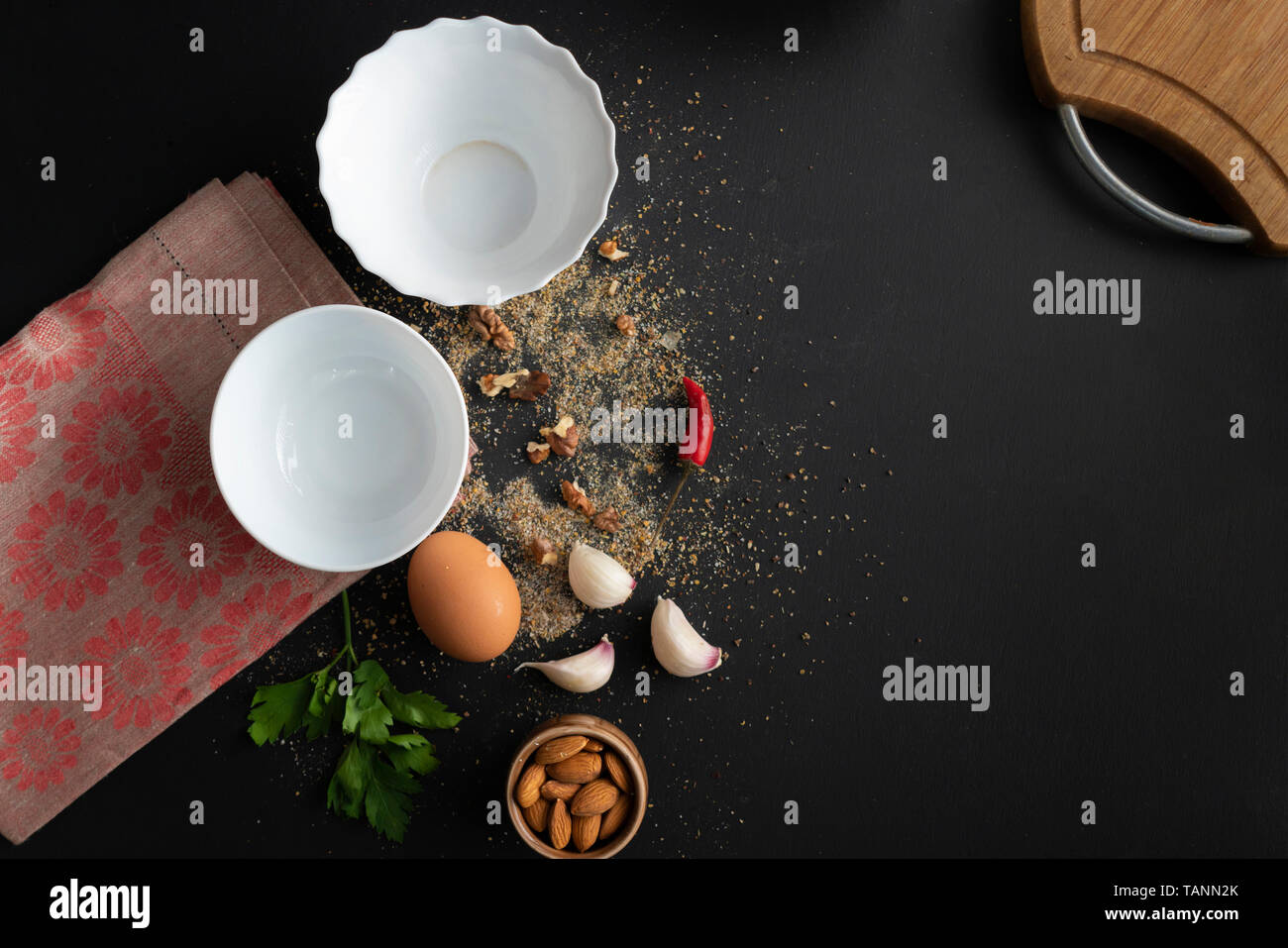 empty white ceramic plate on the black table, fresh ingredients for ...