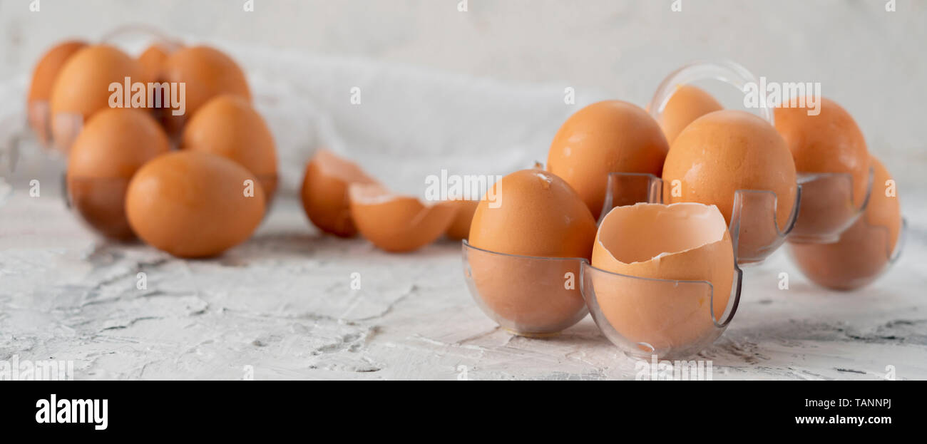 many raw uncooked chicken eggs in a plastic tray on the grunge table ...