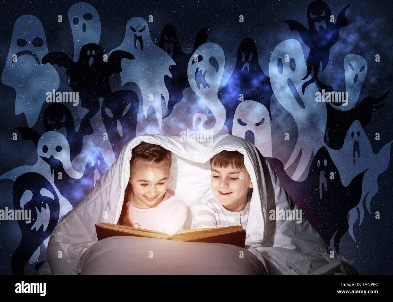 Happy little kids reading book in bed Stock Photo - Alamy