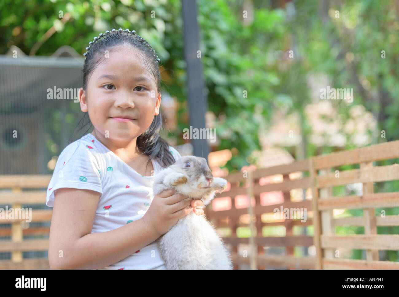Happy cute girl hug rabbit in farm, love pet animal concept Stock Photo ...