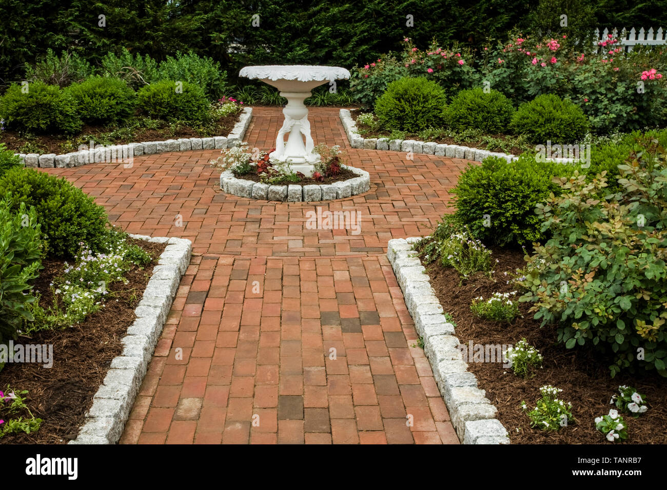 Backyard garden brick walkway with a birdbath in Lancaster county ...