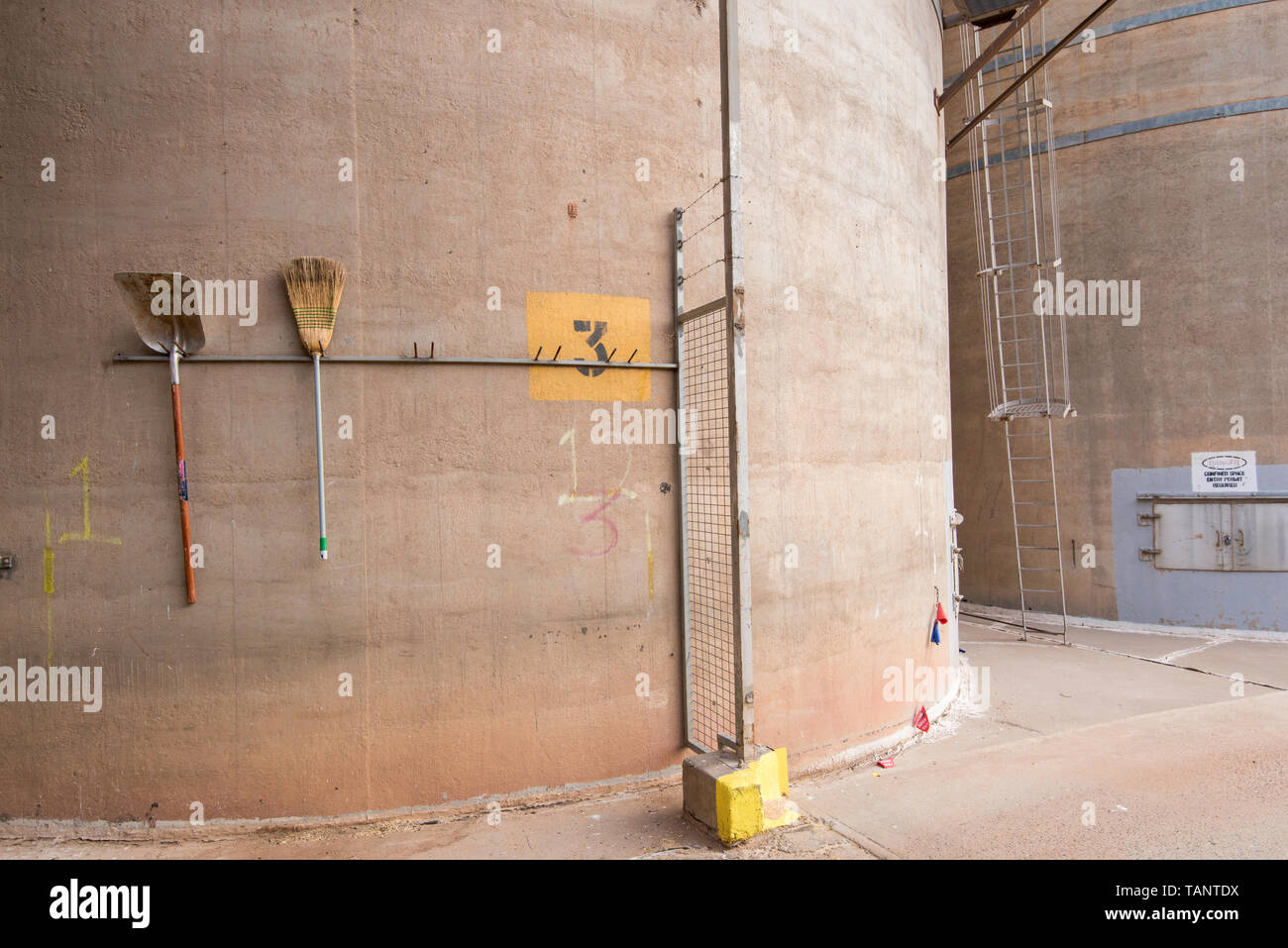 A shovel and broom hang on the wall of a grain silo in the town of ...
