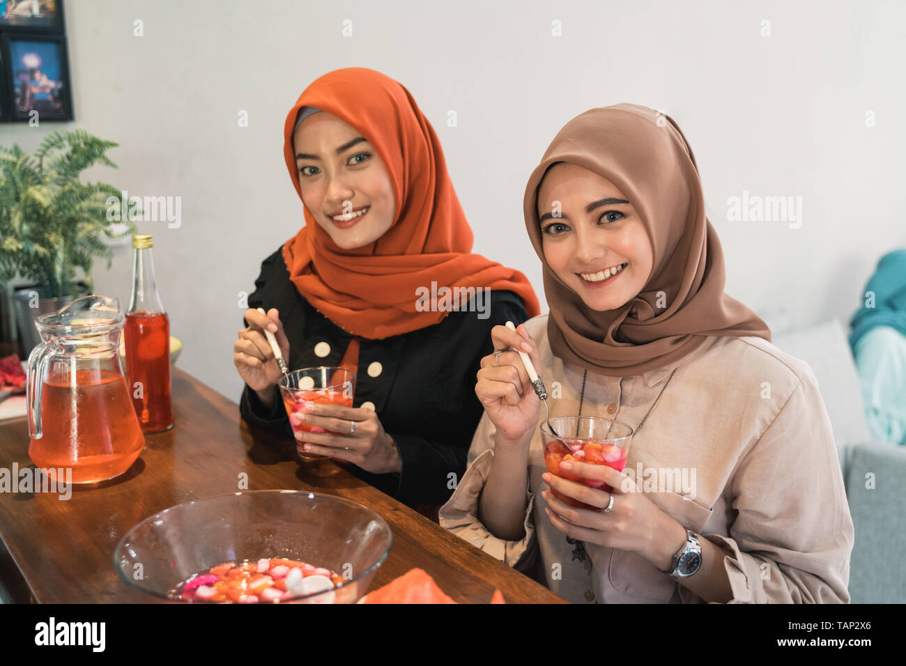 two hijab woman carrying cocktail drink Stock Photo - Alamy