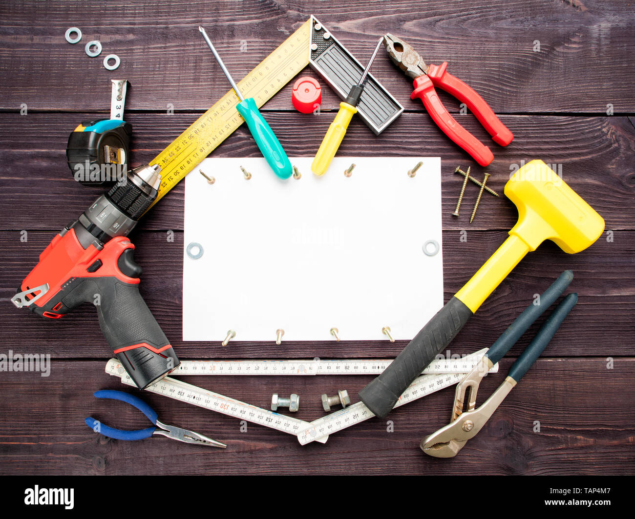 The tool building on the wooden background around the white sheet of ...