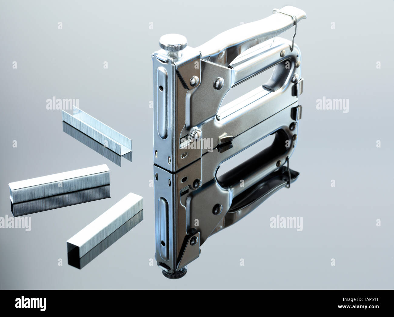 Metal industrial chrome stapler and cassette brackets to it stand on ...