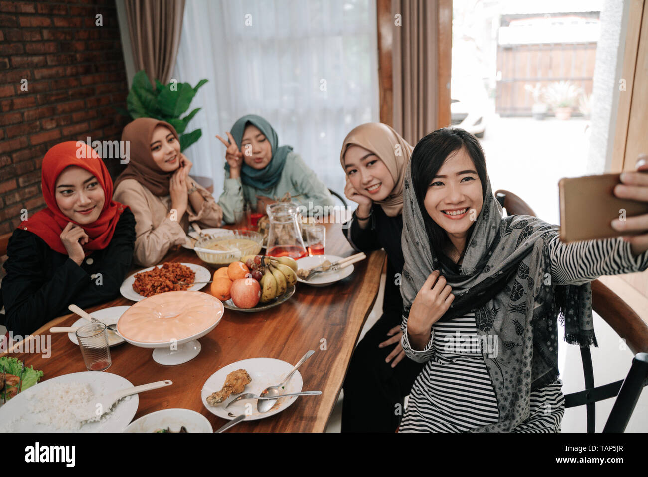 selfie of happy young beautiful women after breaking fast together ...