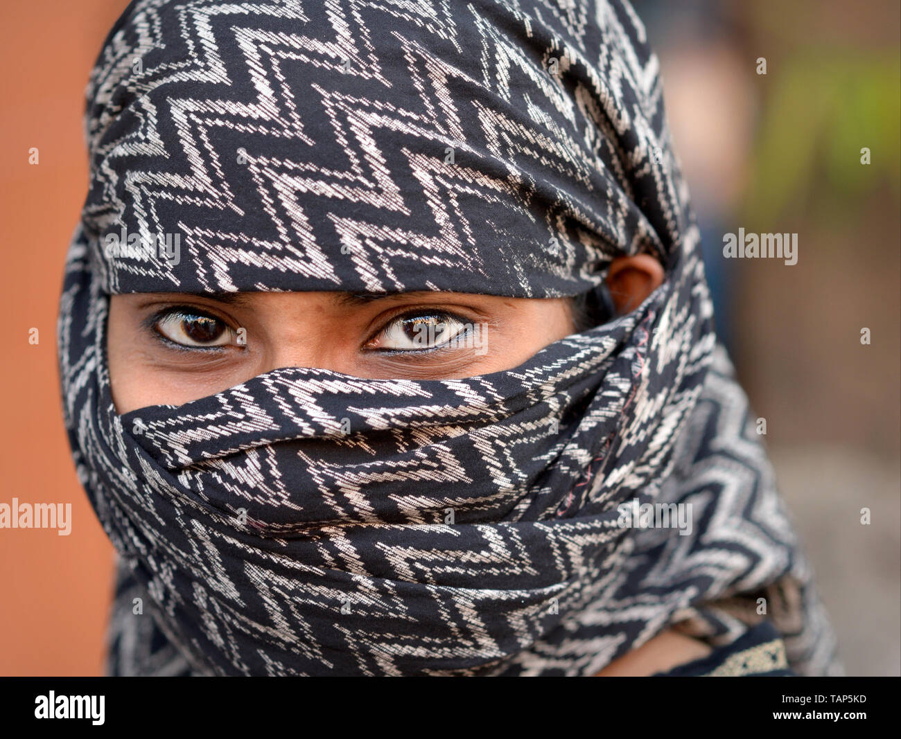 Indian Rajasthani scooter girl with romantic eyes covers her face with ...