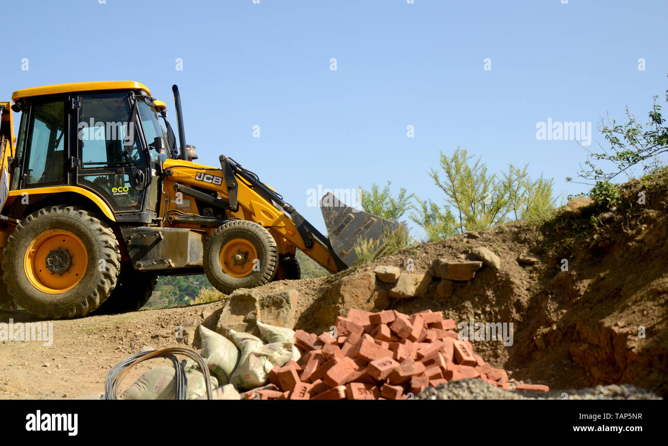 The yellow Bulldozer on the construction of hill highway Stock Photo ...