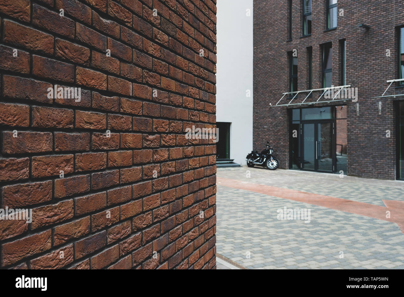 Motorcycle stands in the courtyard of a modern house Stock Photo - Alamy