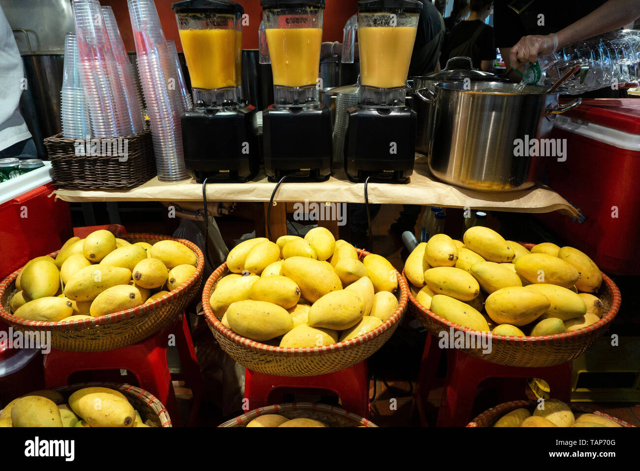 Mango shakes in the Vietnamese market. Fresh mango in basket at the ...
