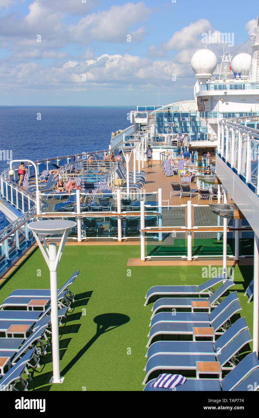 View from the deck of a cruise ship in the ocean. Seating area for ...