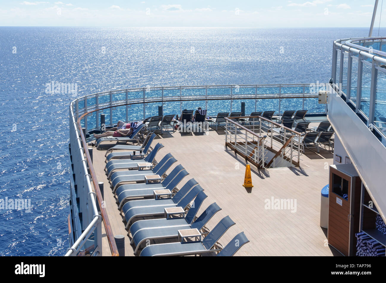 View from the deck of a cruise ship in the ocean. Seating area for ...