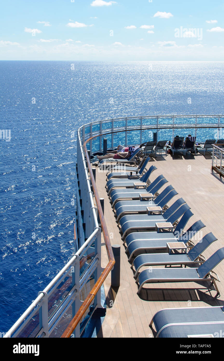 View from the deck of a cruise ship in the ocean. Seating area for ...