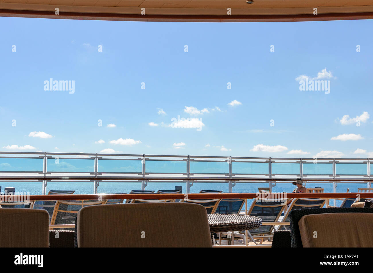 View from the deck of a cruise ship in the ocean. Seating area for ...