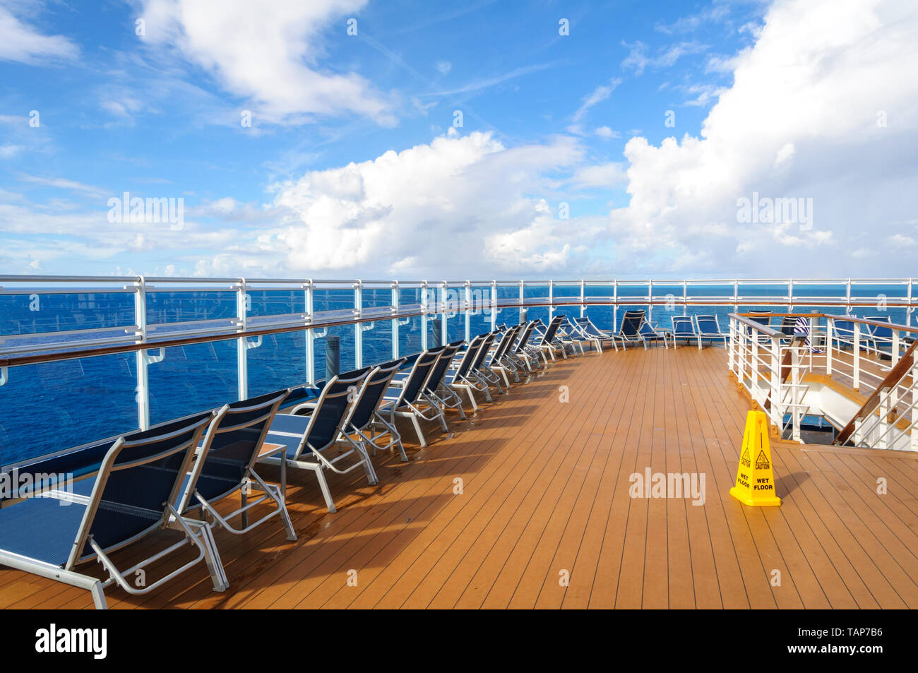 View from the deck of a cruise ship in the ocean. Seating area for ...