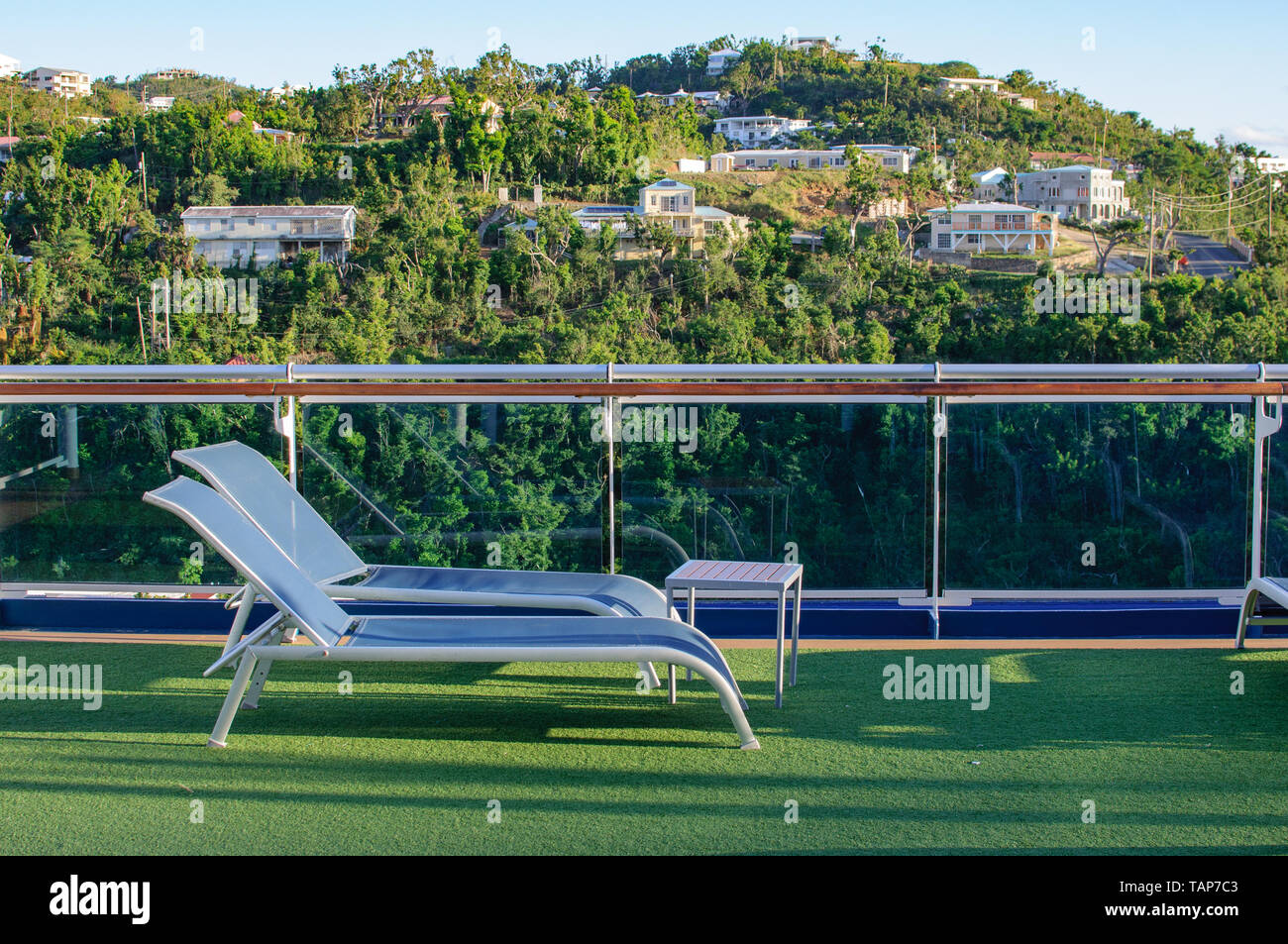 View from the deck of a cruise ship in the ocean. Seating area for ...