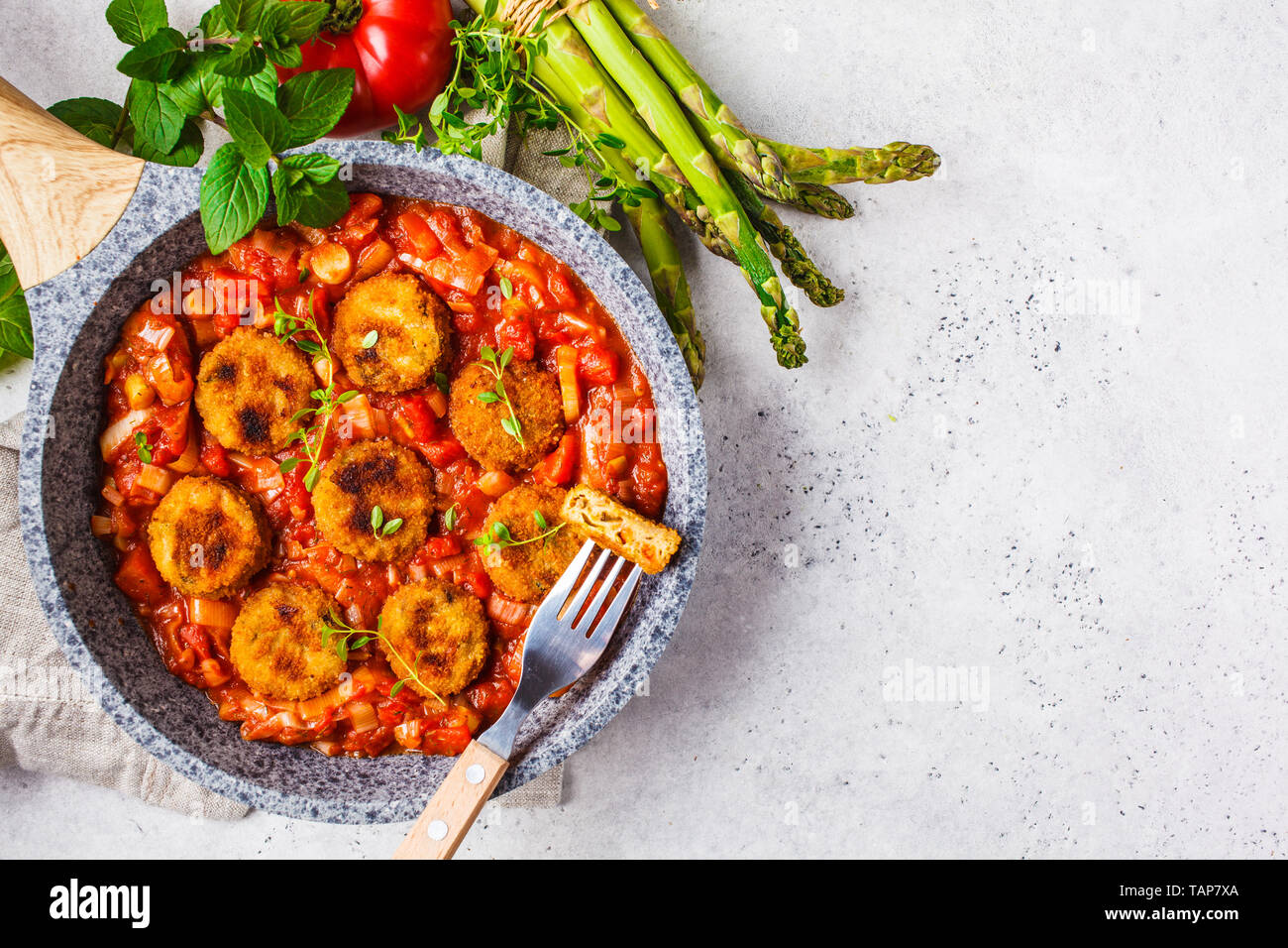 Vegetarian vegetable meatballs in tomato sauce in a frying pan. Healthy ...