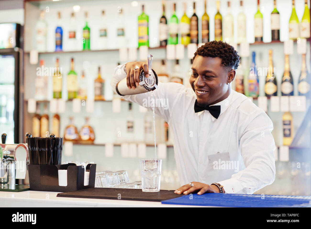 African american bartender at bar with shaker. Alcoholic beverage ...