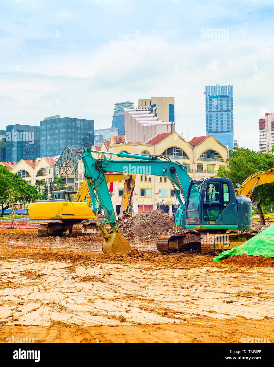 Construction site machinery and digging excavators working on Singapore ...