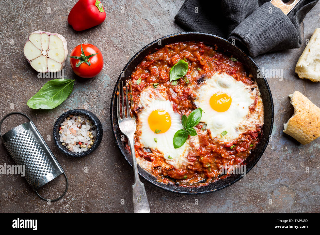Shakshuka, Fried Eggs in Tomato Sauce in iron frying pan. Typical ...