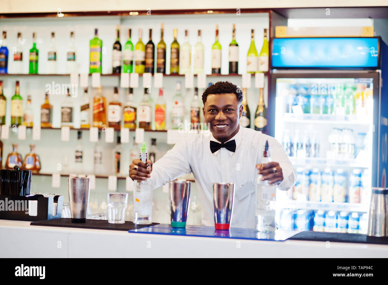 African american bartender working behind the cocktail bar. Alcoholic ...