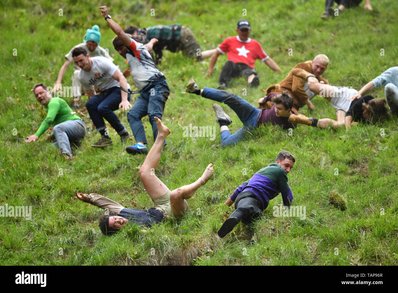 Participants take part in the annual cheese rolling competition at ...