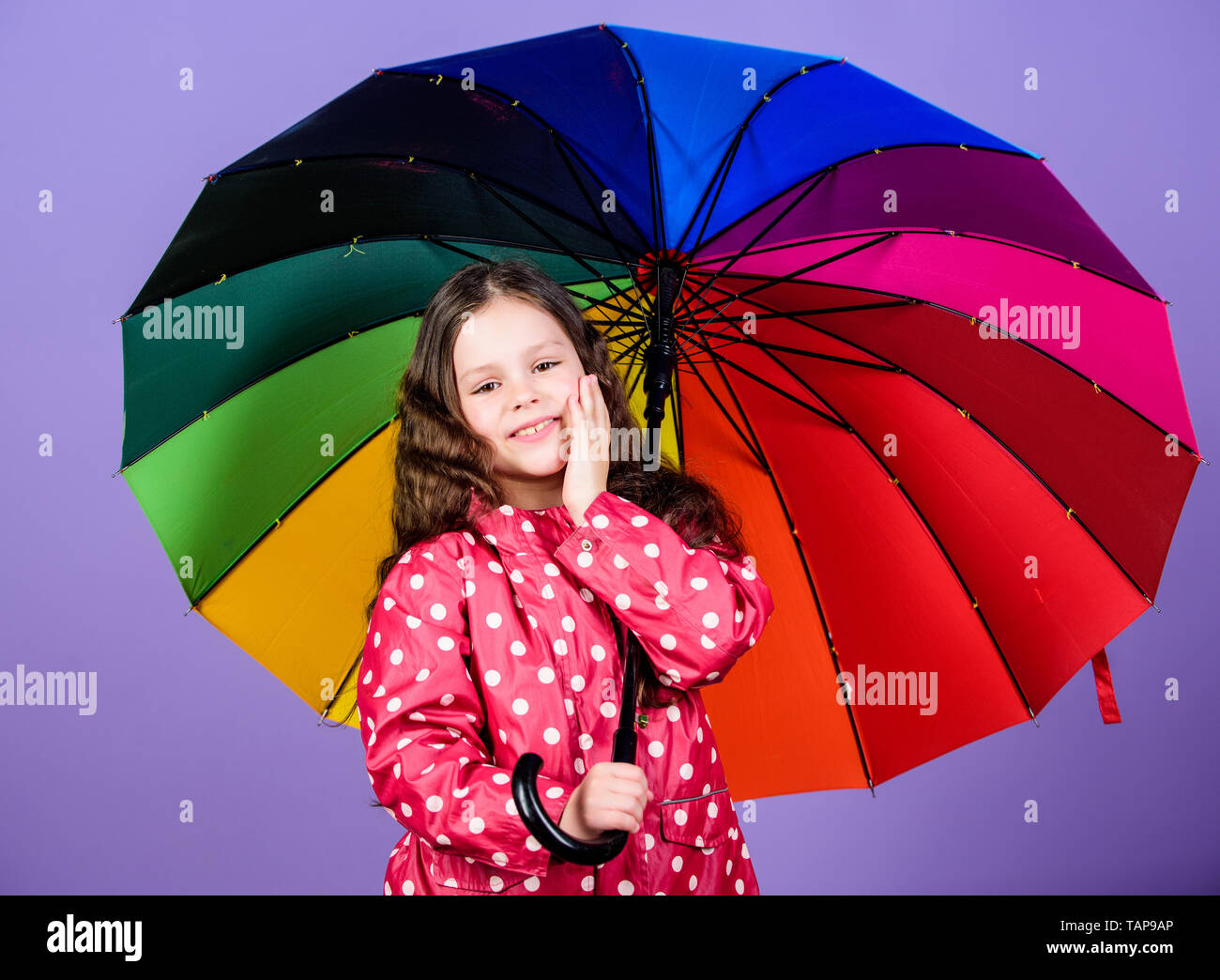 little girl in raincoat. happy little girl with colorful umbrella. rain ...