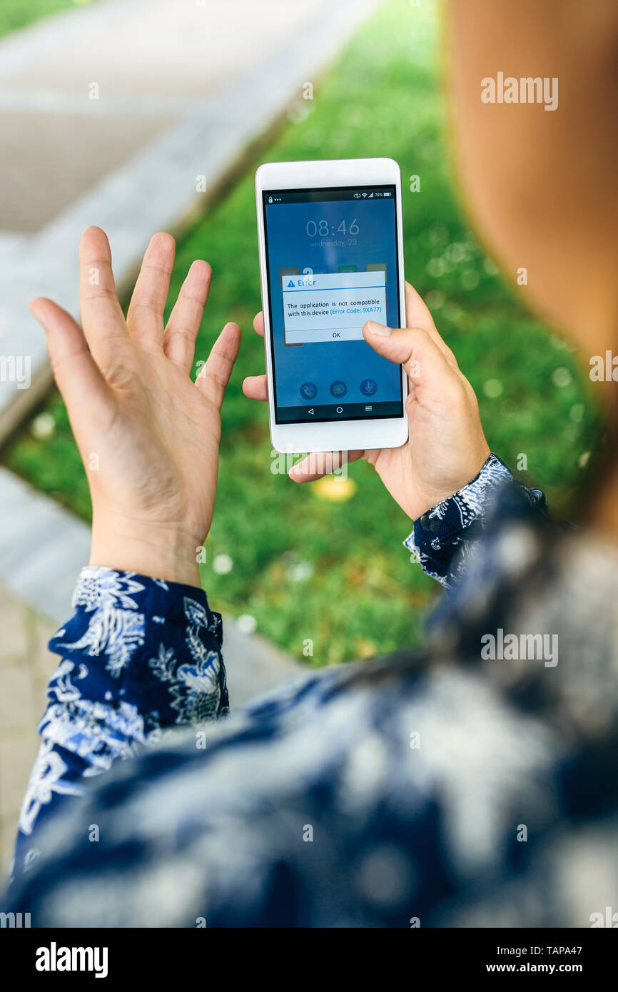 Hands holding phone with app update error text on screen Stock Photo ...