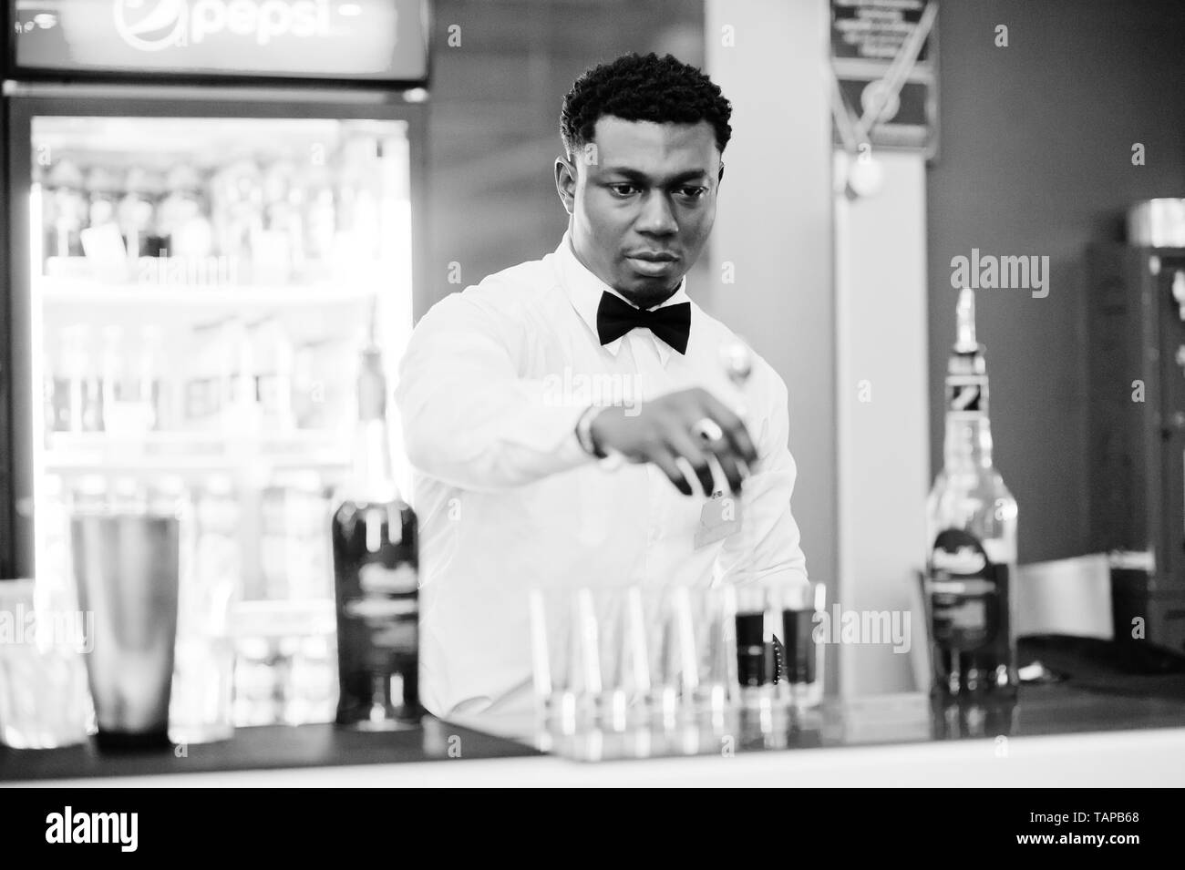 African american bartender at bar making coctails on shots. Alcoholic ...