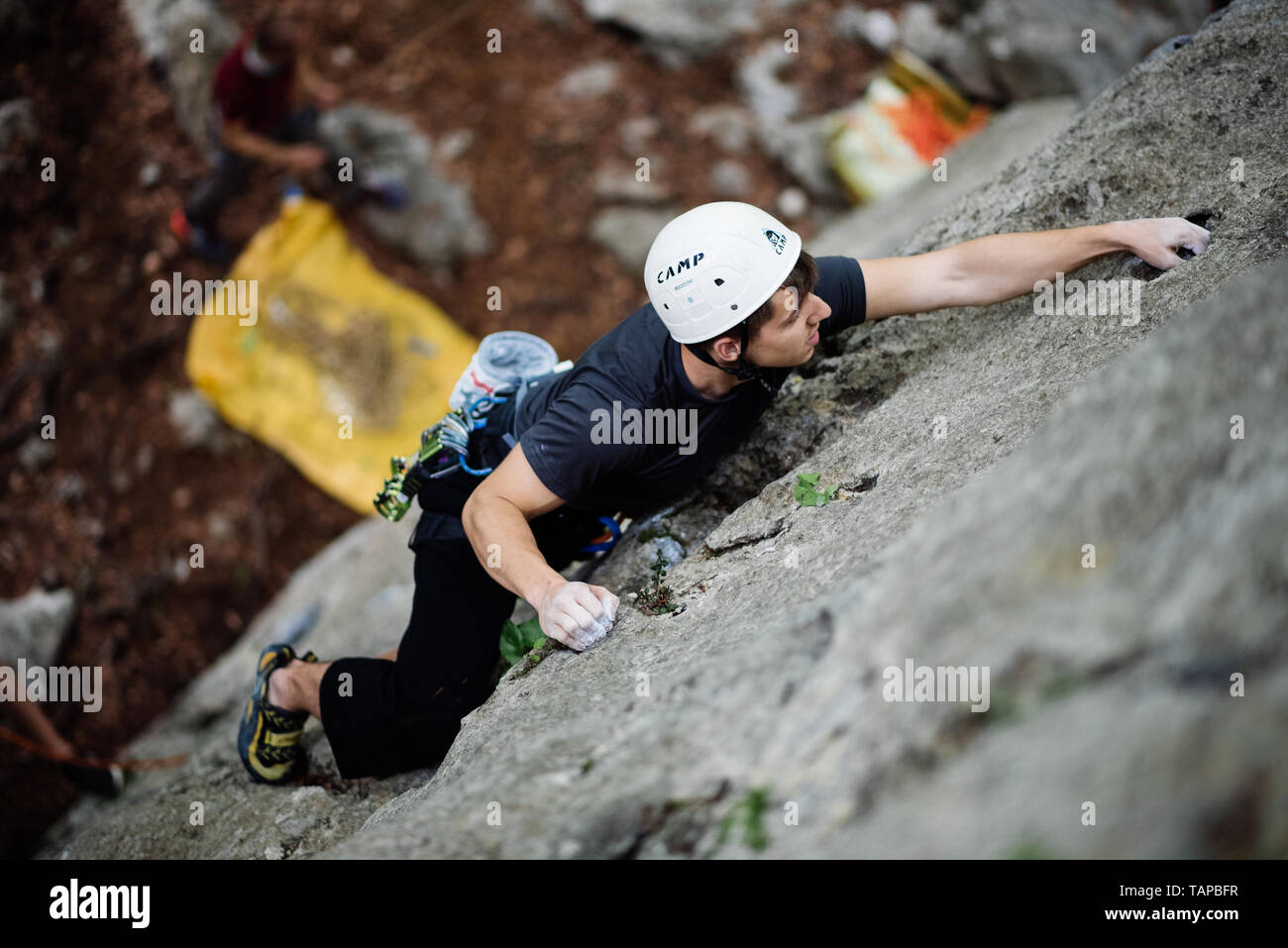 Strong man climbing outside on a mountain Stock Photo - Alamy