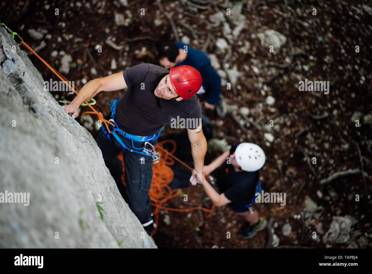 Strong man climbing outside on a mountain Stock Photo - Alamy