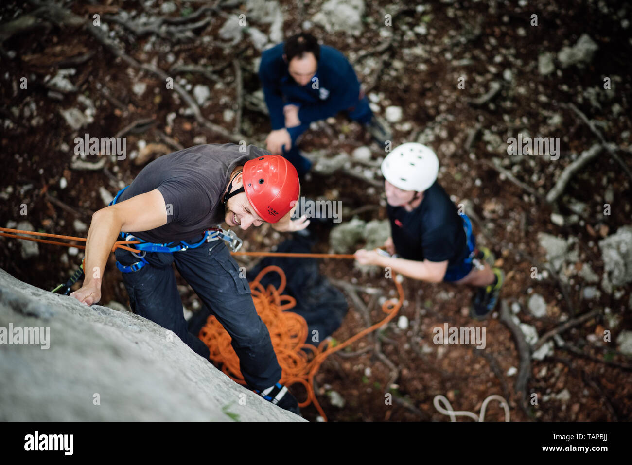 Strong man climbing outside on a mountain Stock Photo - Alamy
