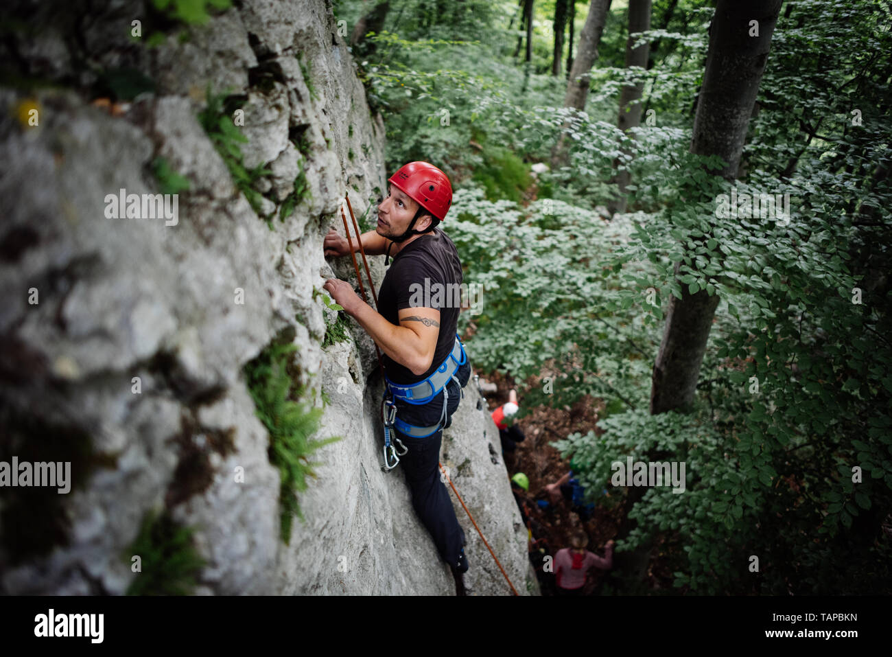 Strong man climbing outside on a mountain Stock Photo - Alamy