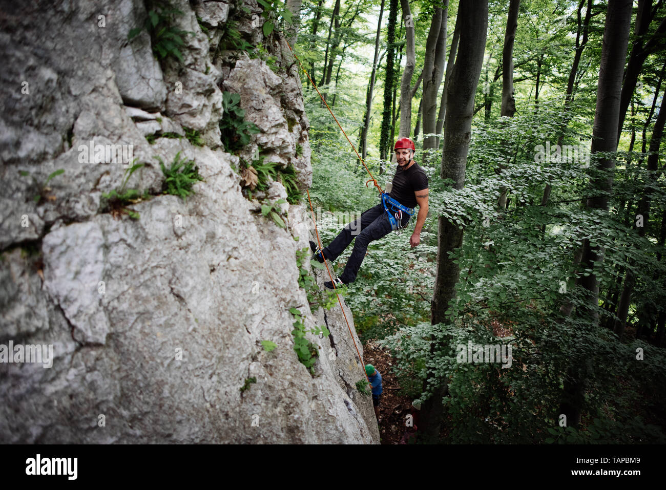 Strong man climbing outside on a mountain Stock Photo - Alamy