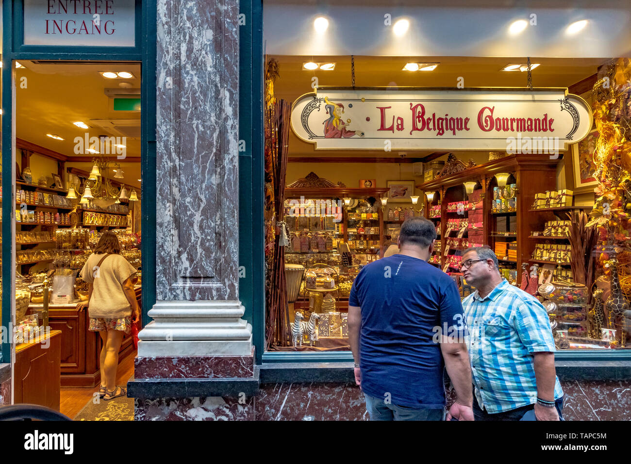 Two men outside La Belgique Gourmande a luxury chocolate shop in Les ...