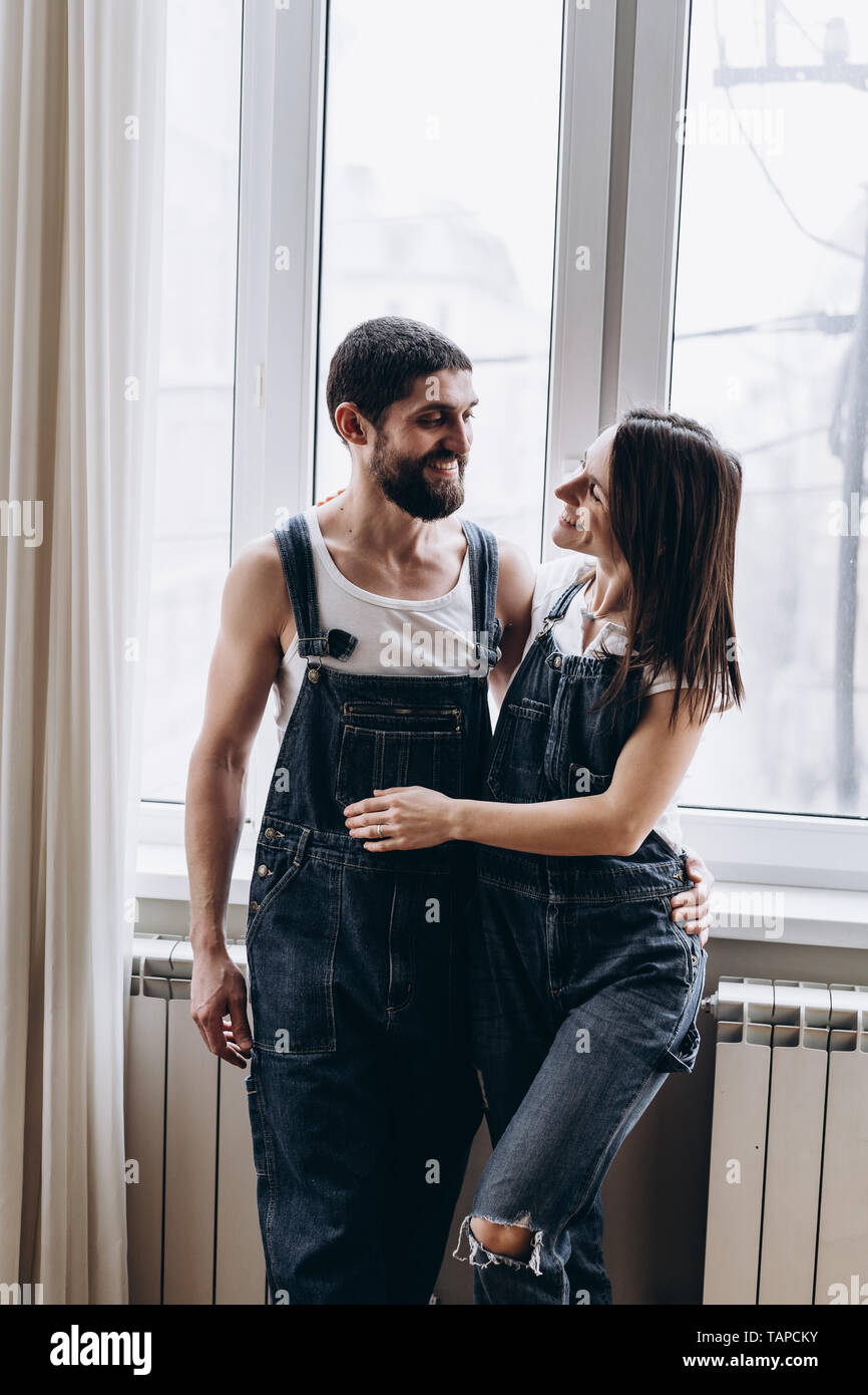 happy young couple standing near the window Stock Photo - Alamy