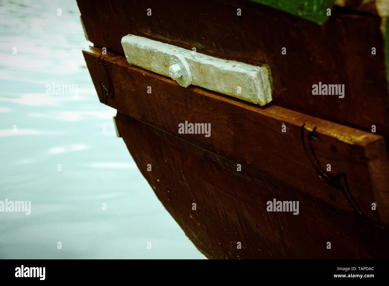 Old wooden boat stern on river and fountain behind Stock Photo - Alamy