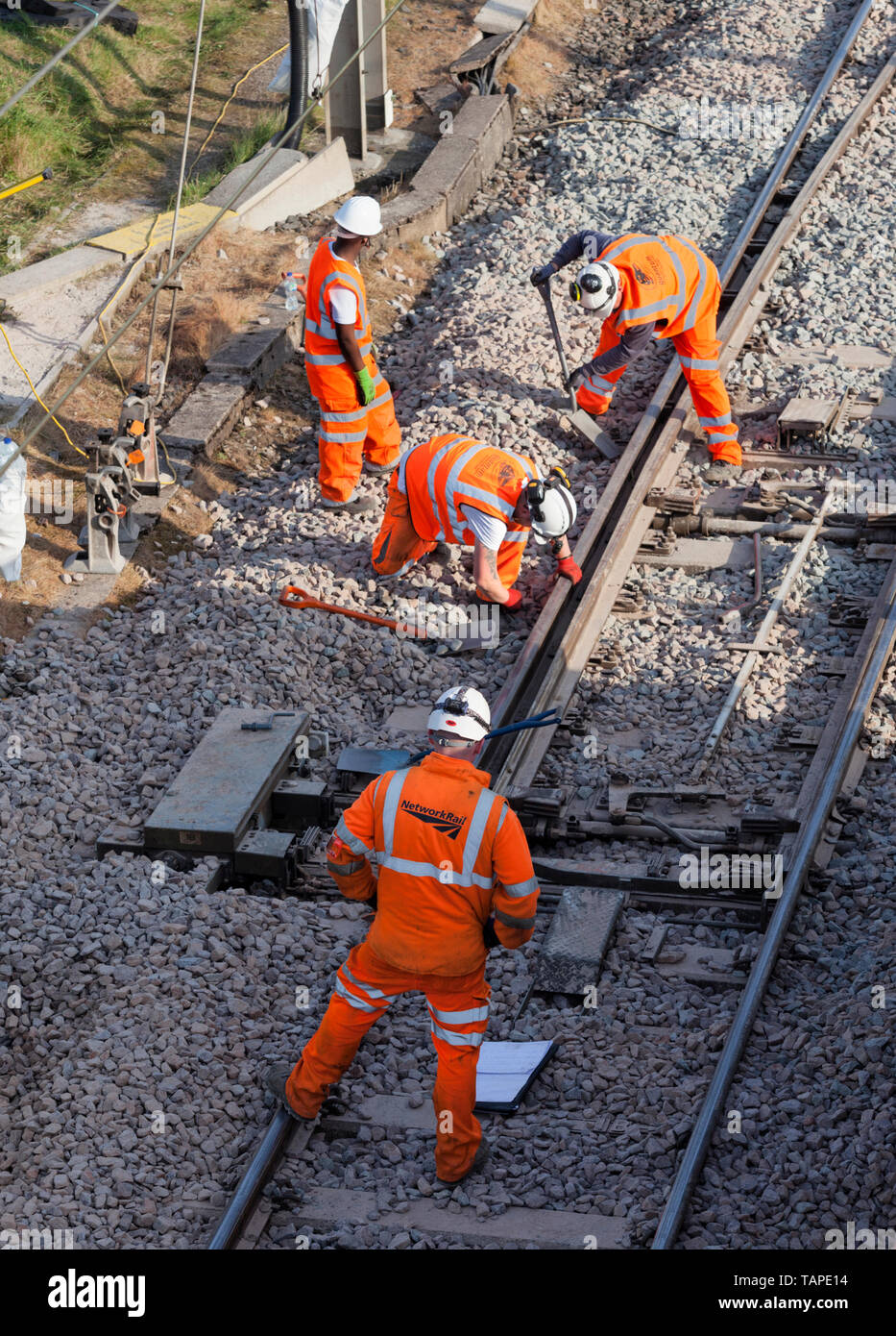 Network rail contractors and a Supervisor clearing excess ballast from ...