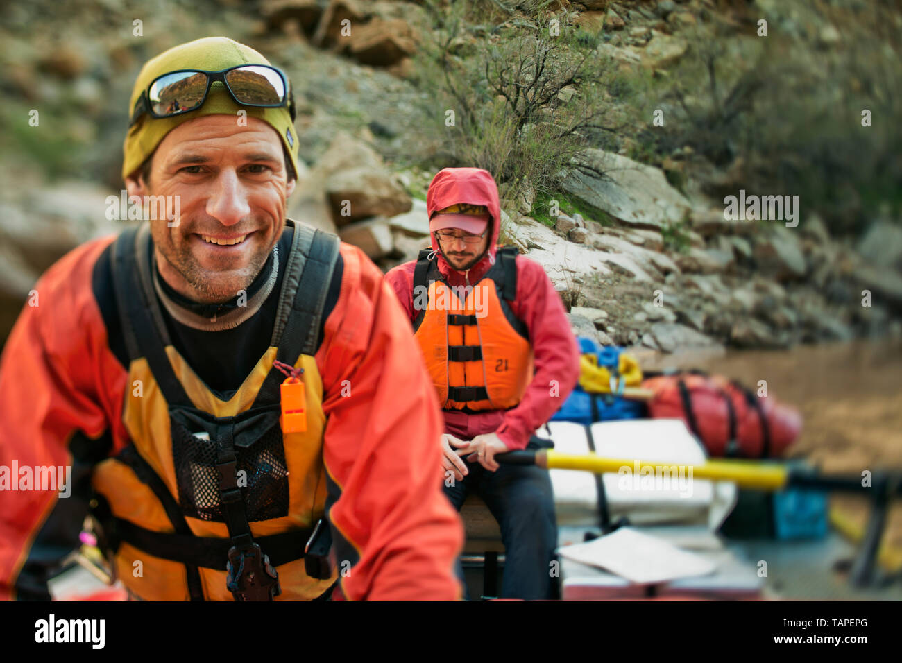 Portrait of a smiling man sitting in a raft Stock Photo - Alamy