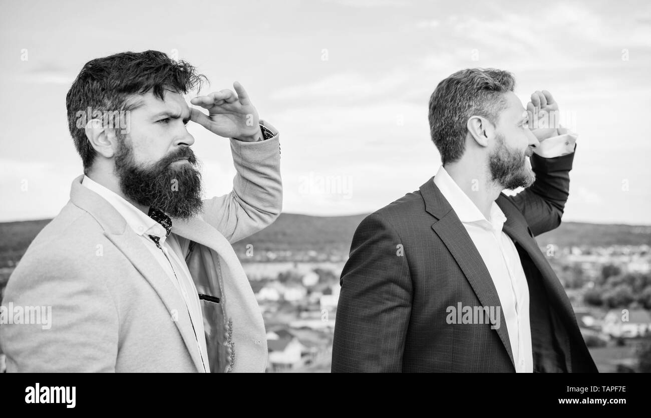 Developing business direction. Men formal suit managers looking at ...