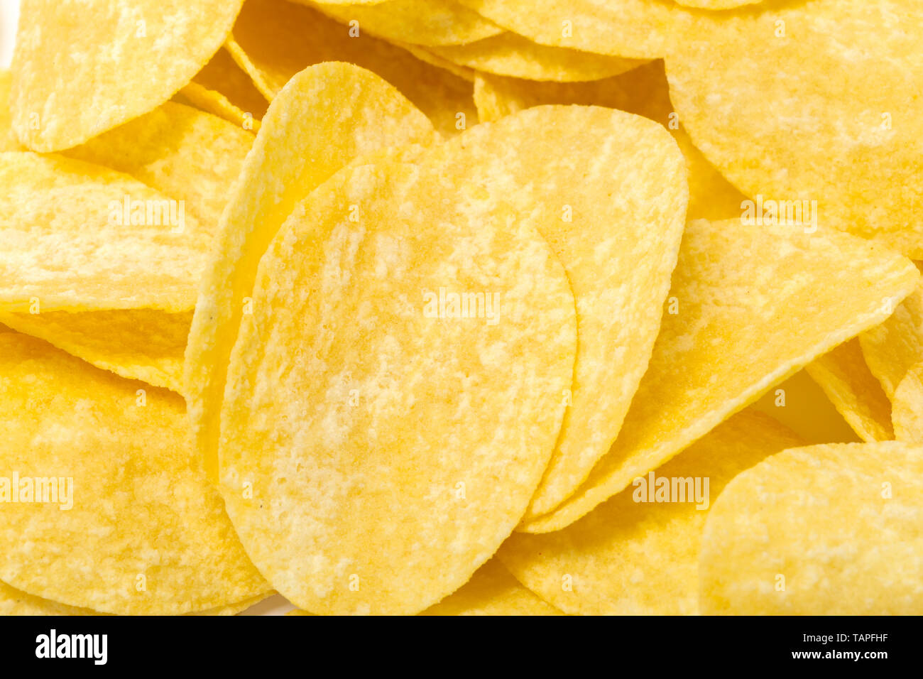 yellow potato chips isolated on white Stock Photo - Alamy