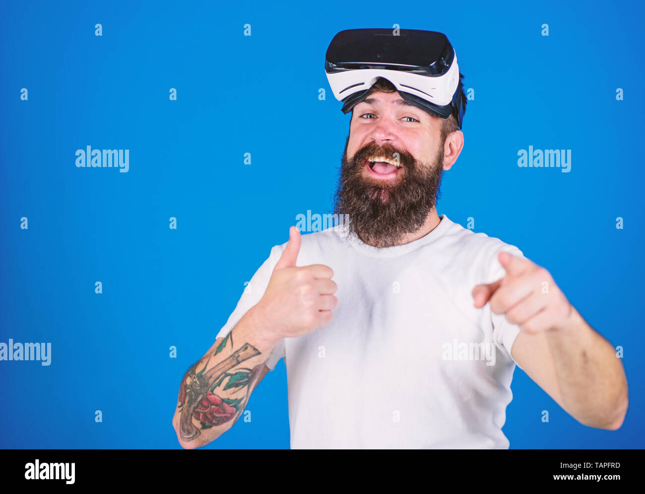 Man with beard and mustache with VR glasses, blue background. VR ...