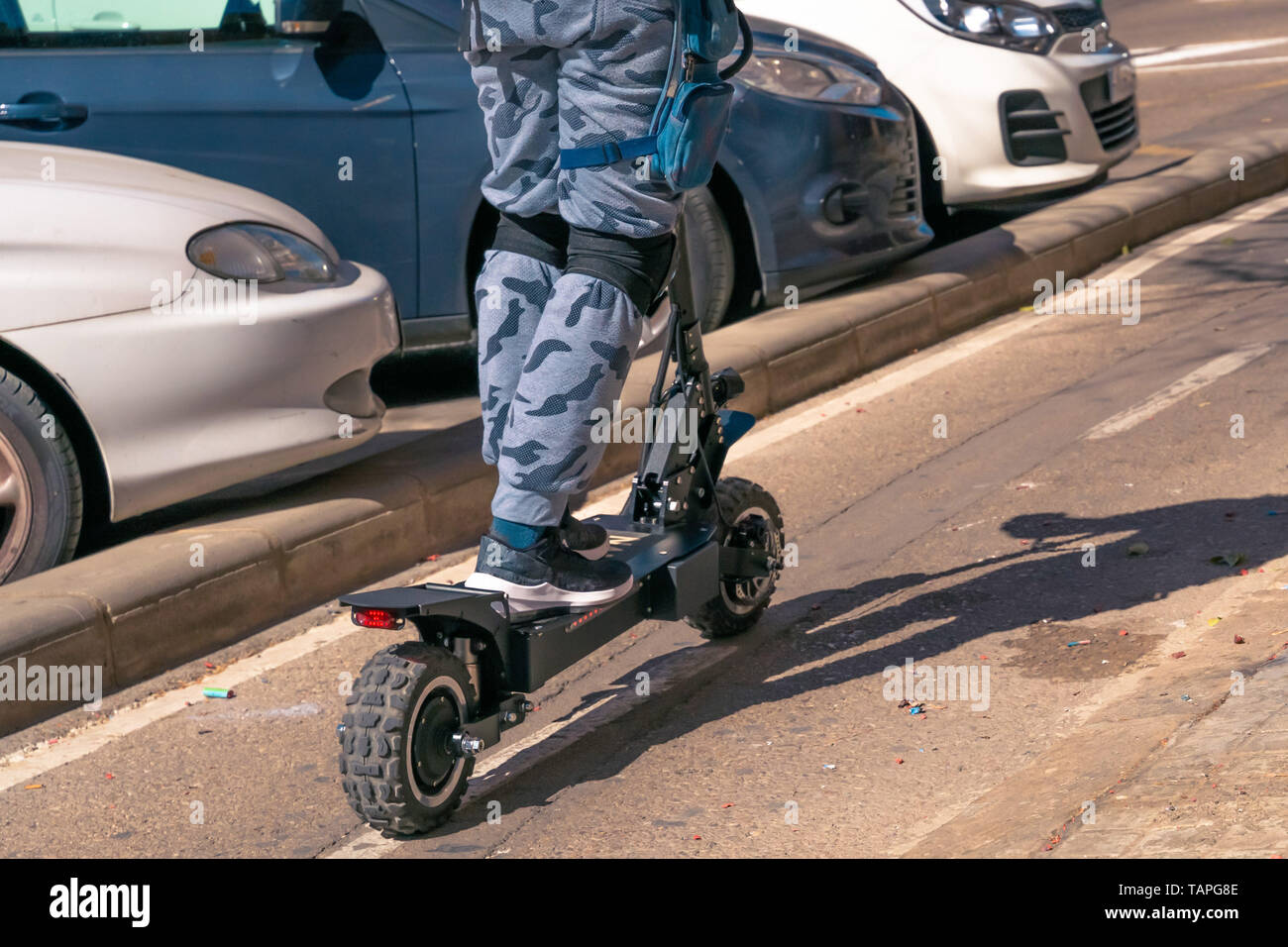 Man driving an electric scooter, powerfull electric scooter, tuned and ...