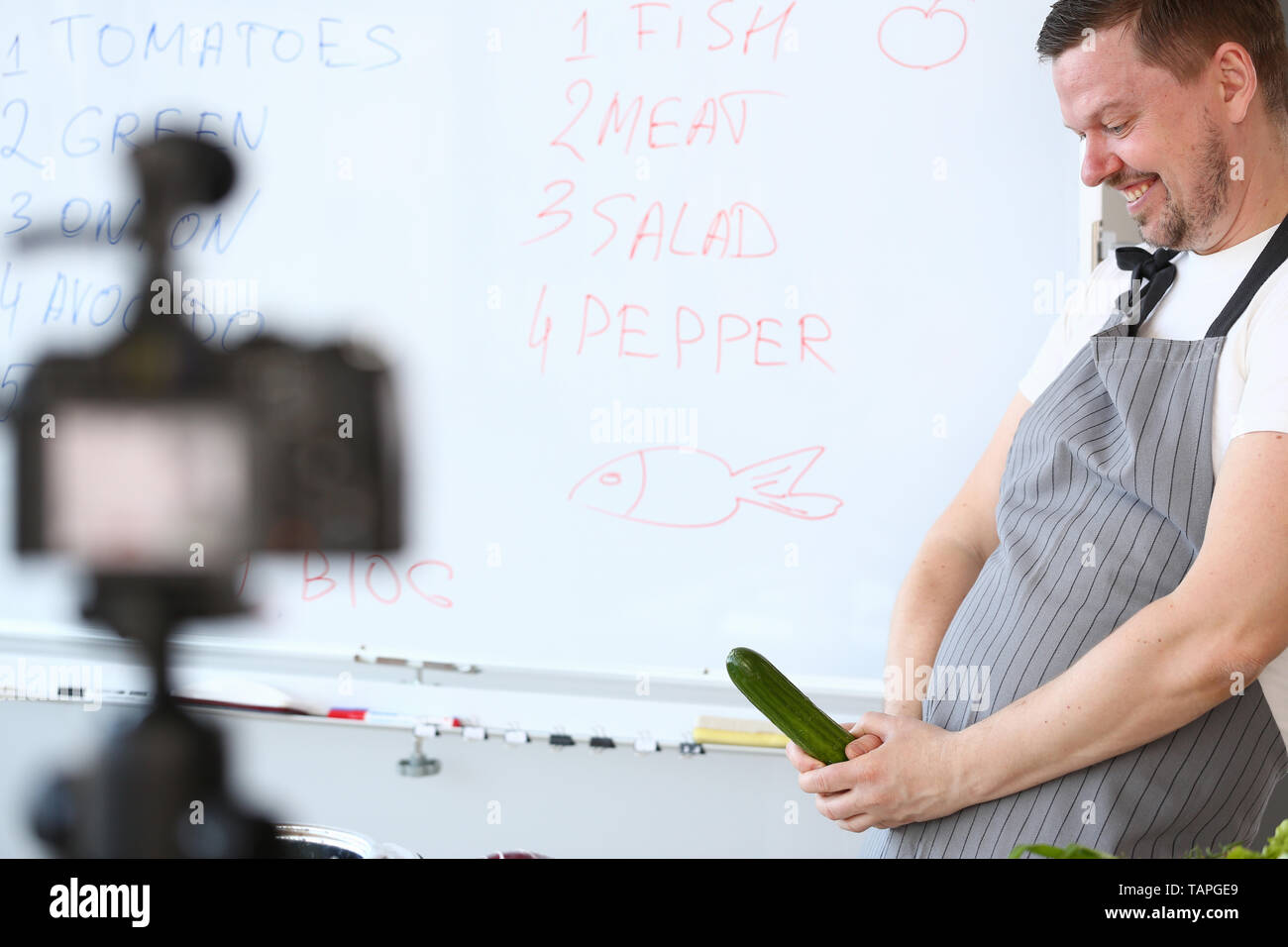 Smiling Vlogger Chef Recording Cucumber Joke Stock Photo - Alamy