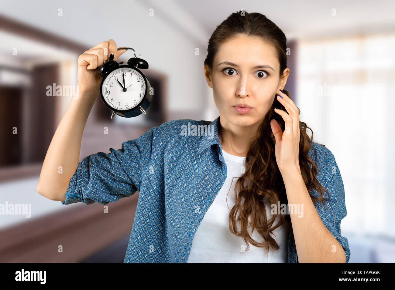 woman holding alarm clock Stock Photo - Alamy