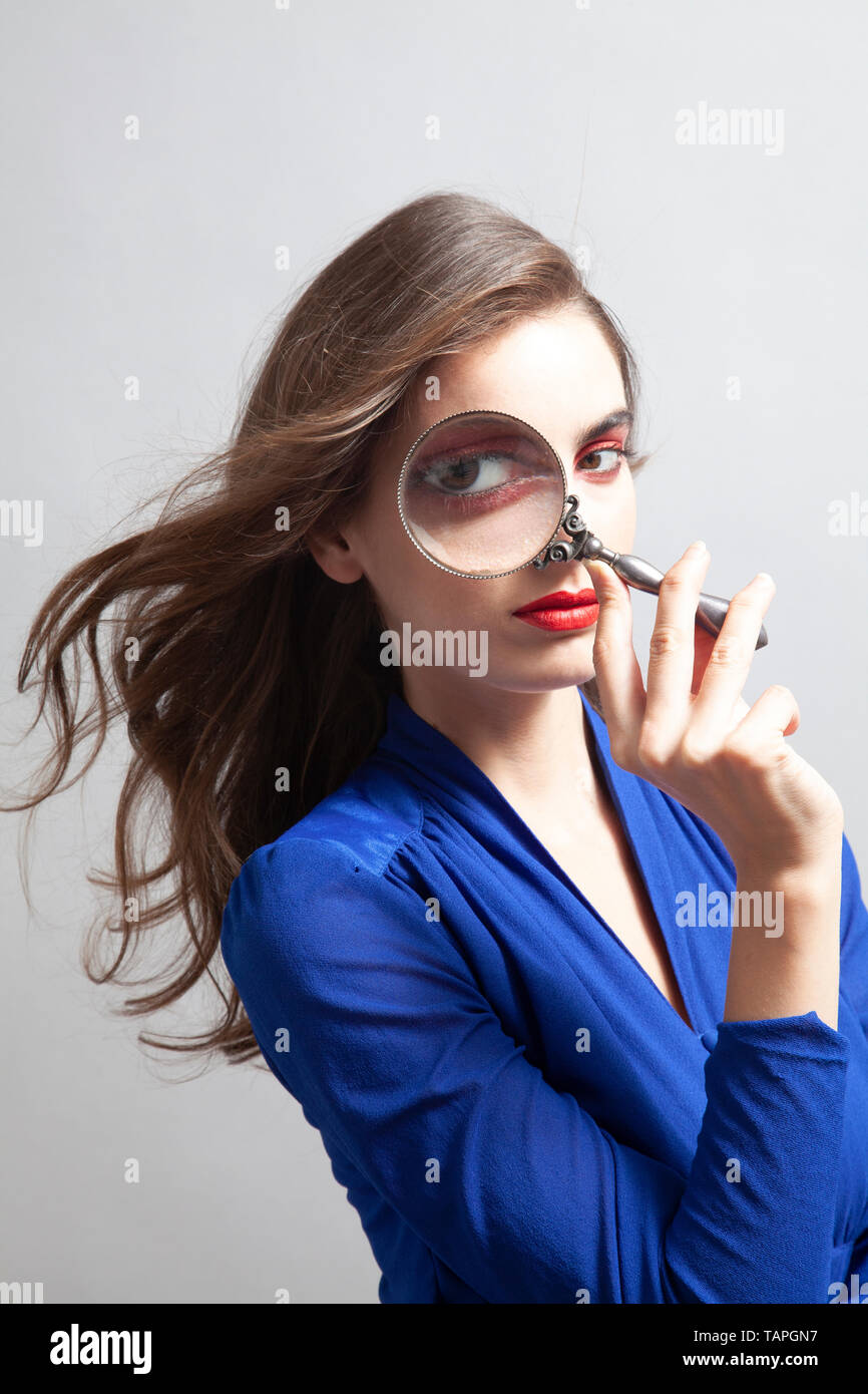 Woman Holding Magnifying Glass over Eye Stock Photo - Alamy