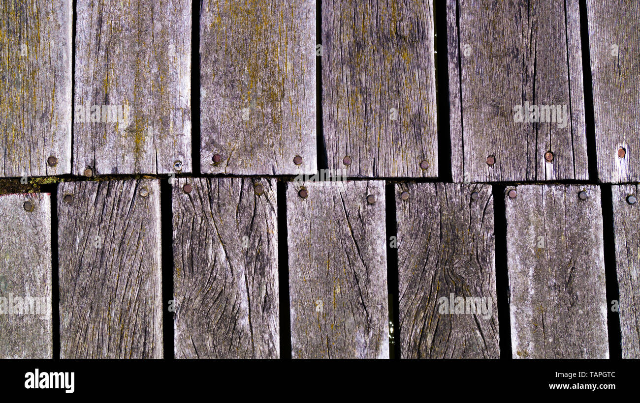 Top down view of old wooden pier planks forming wooden textured pattern ...