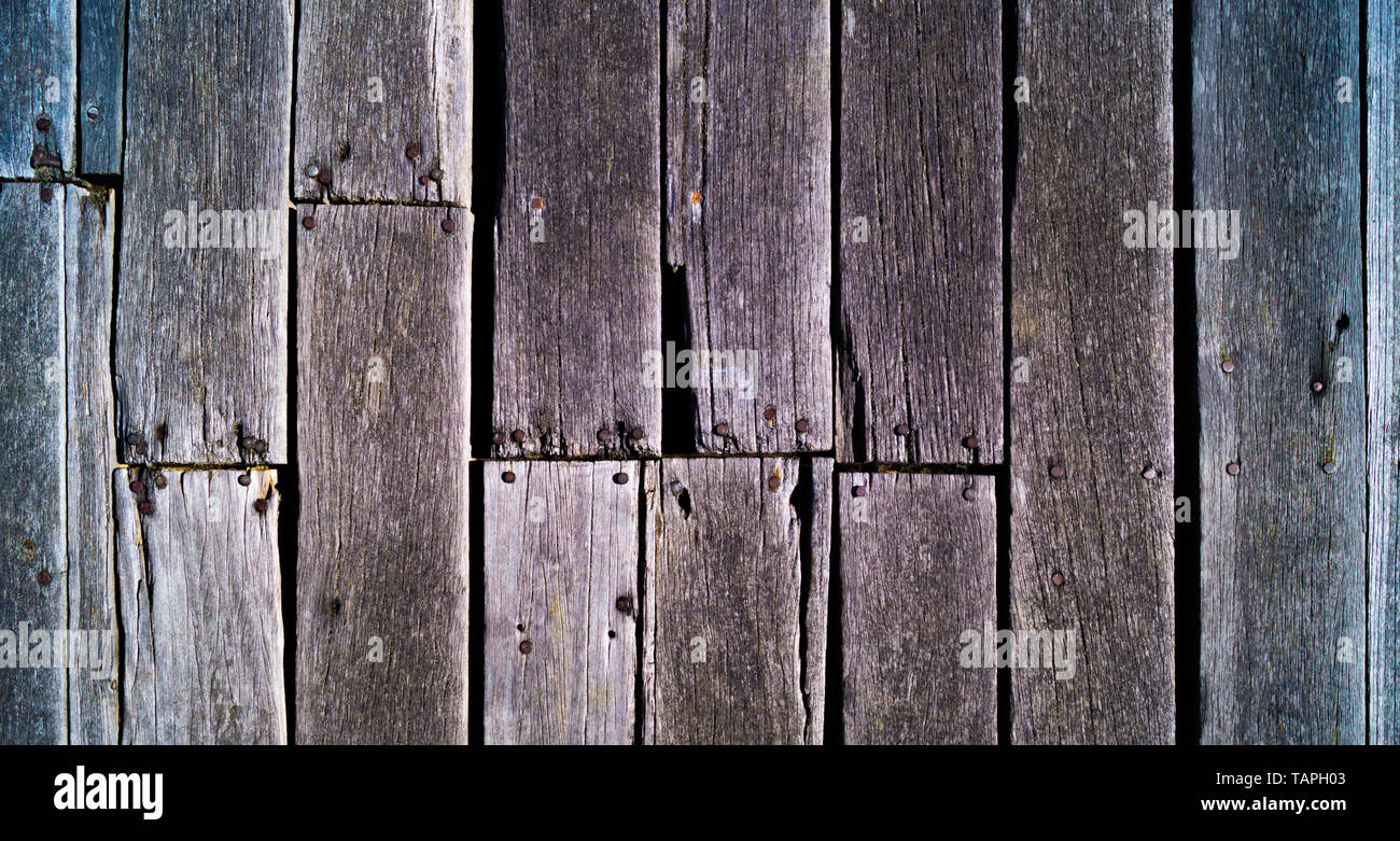 Top down view of old wooden pier planks forming wooden textured pattern ...