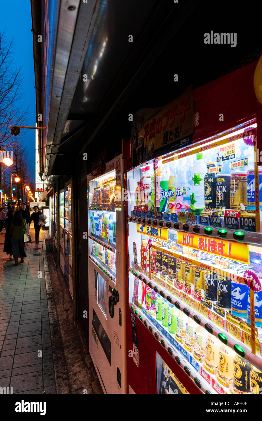 View along row of Japanese soft drink vending machines on street at ...