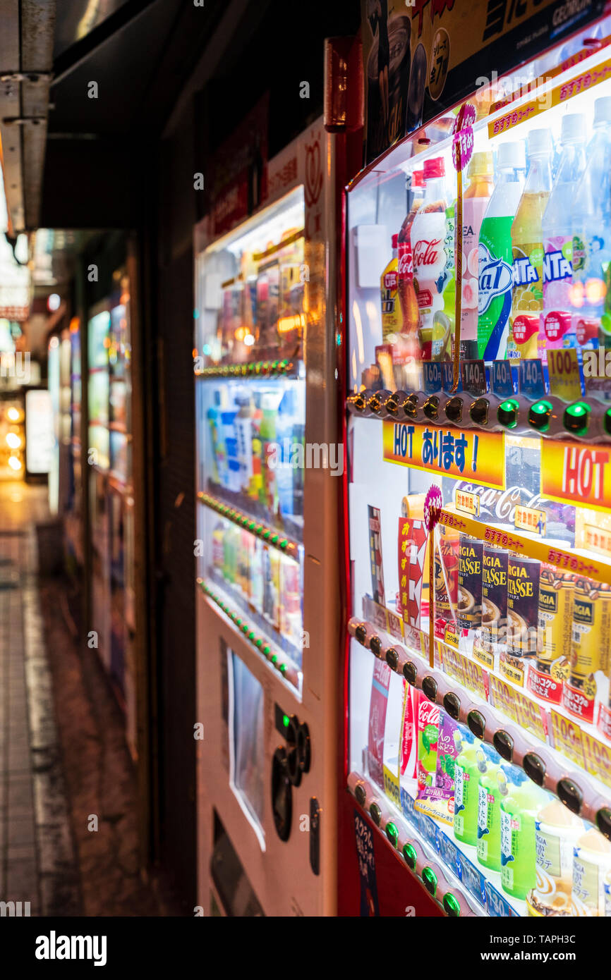 View along row of Japanese soft drink vending machines on street at ...